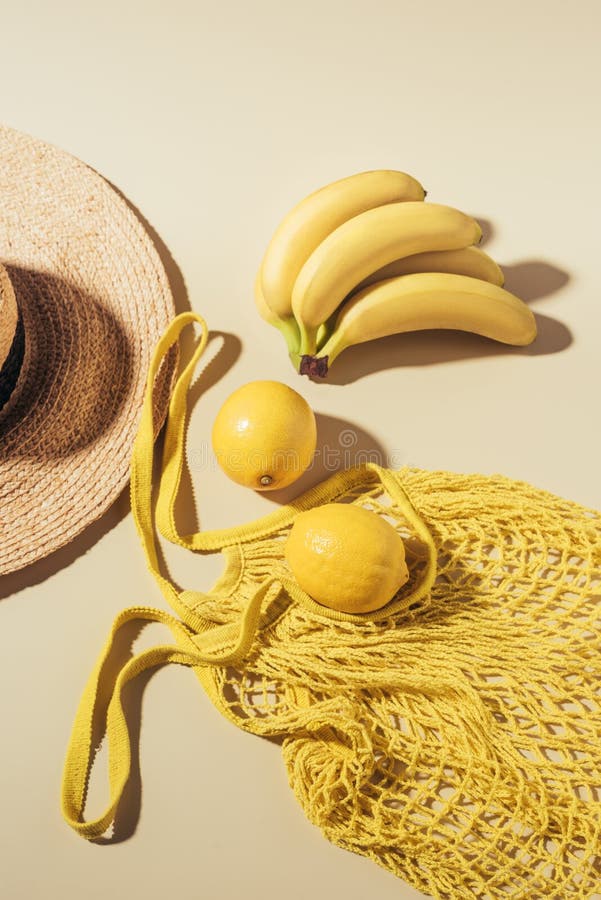 Top View of Straw Hat and Yellow String Bag with Lemons Stock Photo ...