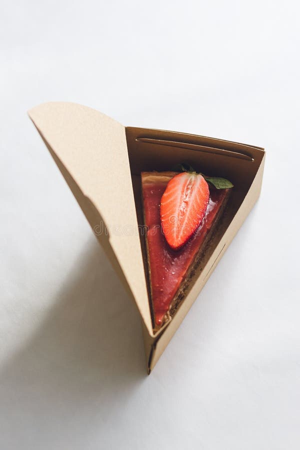 Top View of a Strawberry Cheesecake in a Triangular Cake Box Stock ...