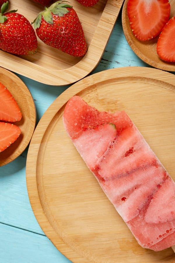 Strawberry Slices Popsicle with a Bite with Fresh Strawberries Vertical ...