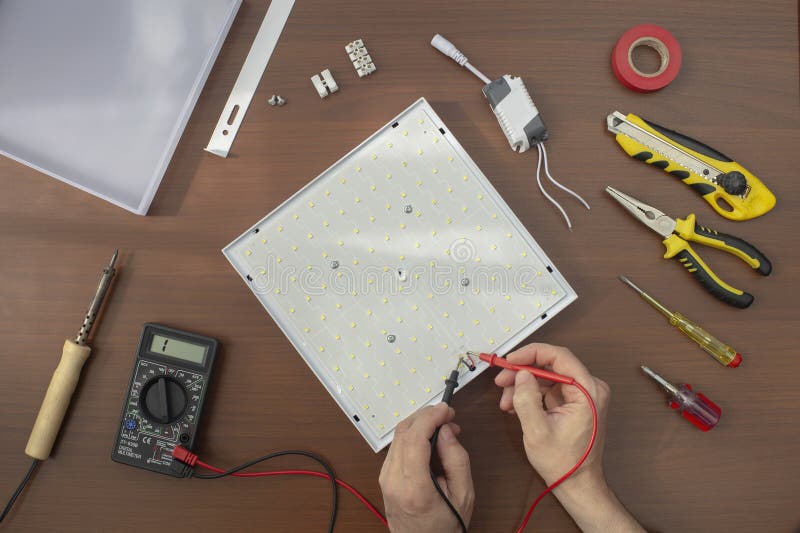 Table with Tools, Where an Electrical Technician is Repairing an LED ...