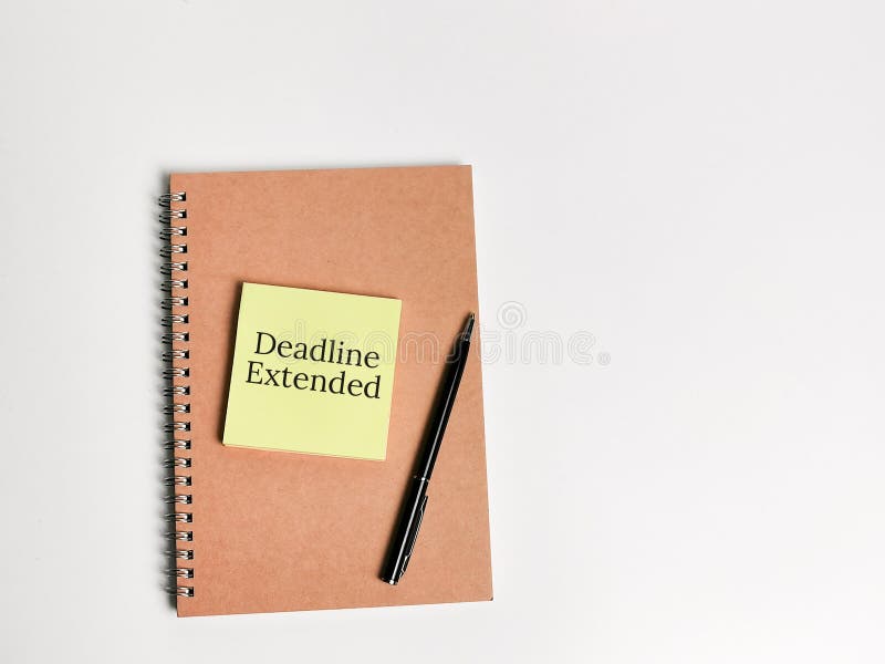Top View Text DEADLINE EXTENDED Written on Sticky Note with a Pen and ...