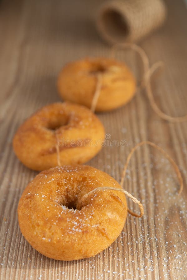 Top View of Three Donuts with Roll of Rope, on Wooden Board, with ...