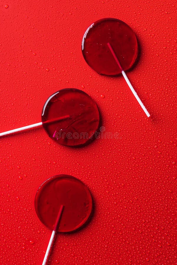 Top View of Three Lollipops on Red Surface Stock Image - Image of ...