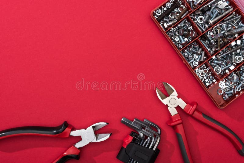 Top View of Tool Box with Pliers and Hex Keys on Red Surface Stock ...