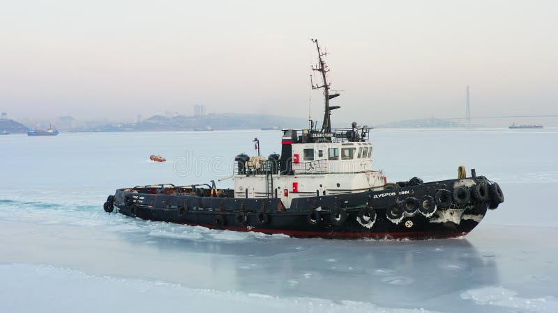 Top View of a Tug Making Its Way through the Ice at Sunset Stock Video ...