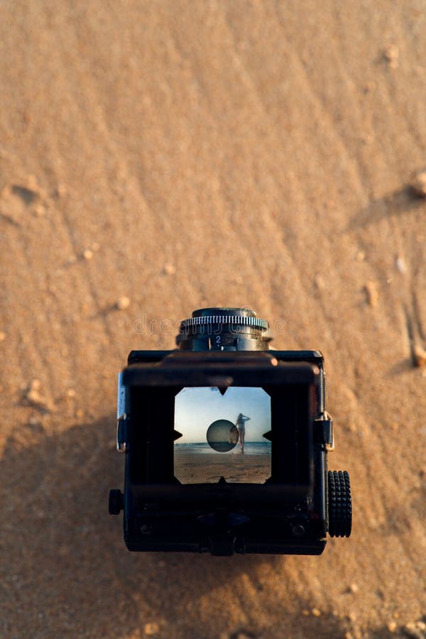 Top View of a Twin-lens Reflex Camera on the Sand with the Reflection ...