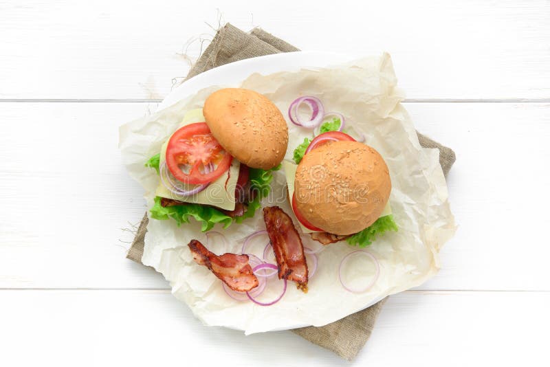 Top View of Two Burgers Served on Baking Paper Over White Rustic Table ...