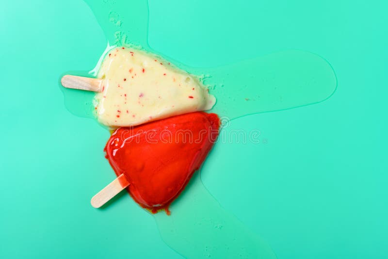 Two Different Colors Chocolate Outer Popsicles Melting on Light Green ...