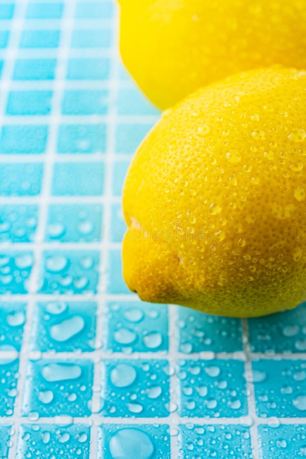 Top View of Two Wet Lemons on Light Blue Ceramic with Water Drops ...