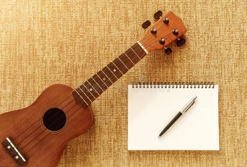 Top View with Ukulele on Sofa There are Notebooks and Pens for D Stock ...