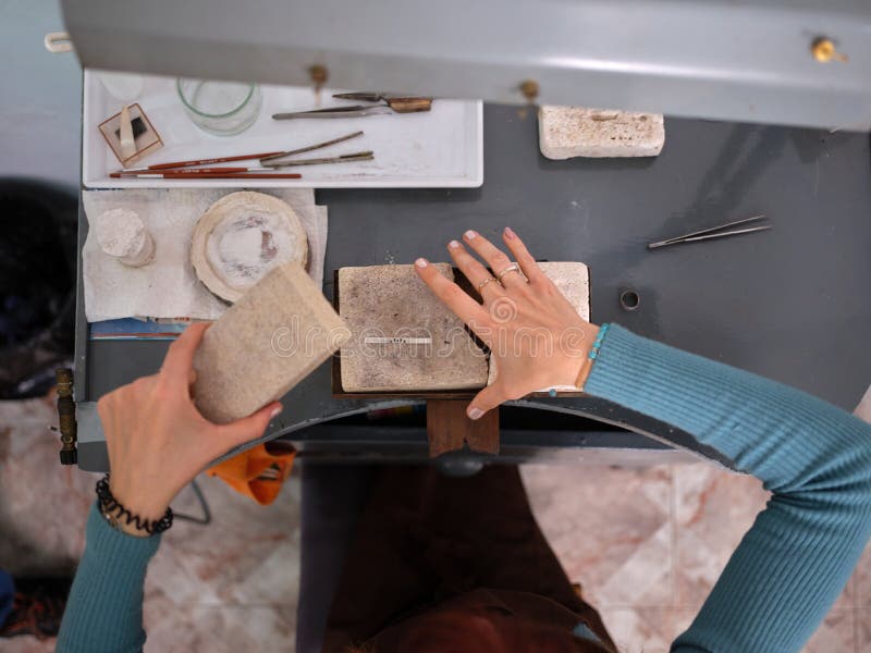 An Adult Woman Working in Her Artisan Jewelry Workshop Sitting at a ...