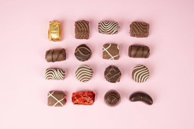 Top View of Various Chocolate Pralines on Pink Background. Collection ...