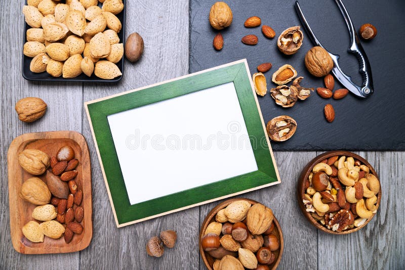 Top View of Various Nuts in Wooden Bowls and Nutcracker on Gray Surface ...