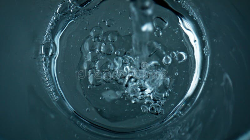 Top View Water Pouring Transparent Cup Closeup. Diverse Air Bubbles ...