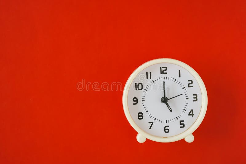 Top View of White Clock at Five O`clock on Red Background Stock Photo ...