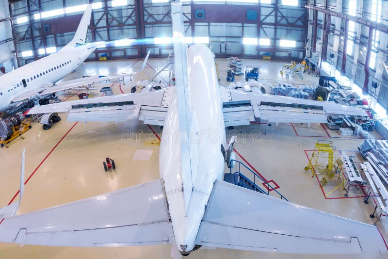 Top View of a White Passenger Aircrafts in the Hangar. Airplanes Under ...