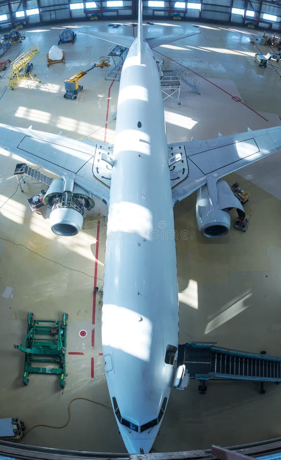 Top View of a White Passenger Jet Plane in the Hangar. Airplane Under ...