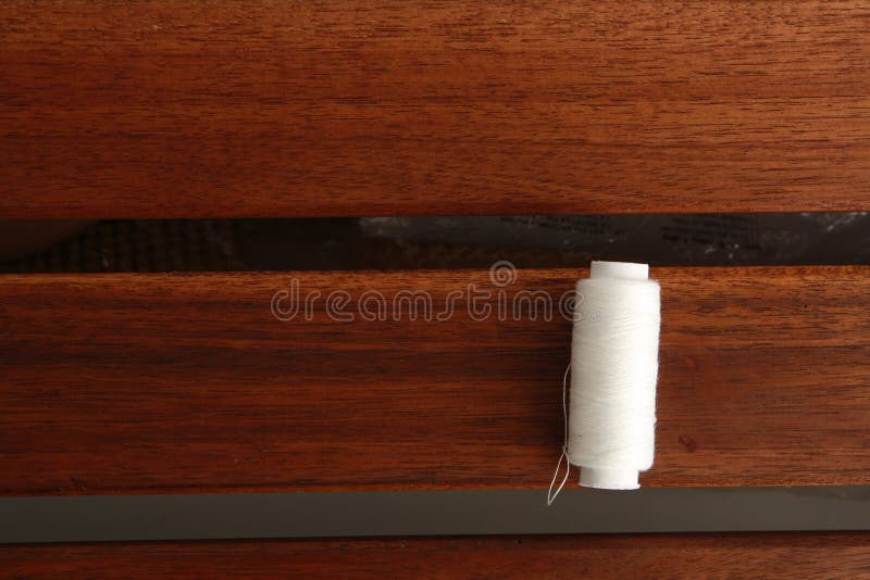 Top View of a White Sewing Thread on a Wooden Table Stock Photo - Image ...