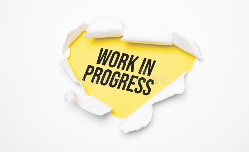 Top View of White Torn Paper and the Text Work in Progress on a Yellow ...