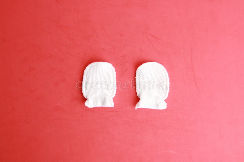 Top View of White Wool Baby Mittens on a Red Background Stock Photo ...