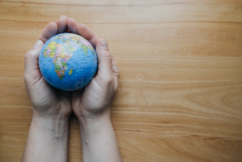 Top View of Woman`s Hand with Globe on Wooden Table. Empty Space Stock ...