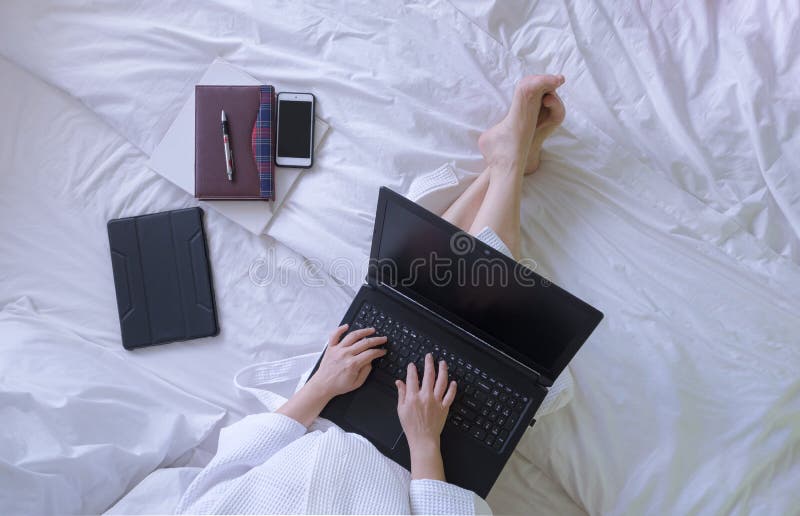 Top View of Woman in White Bathrobe Using Laptop Computer with Books ...