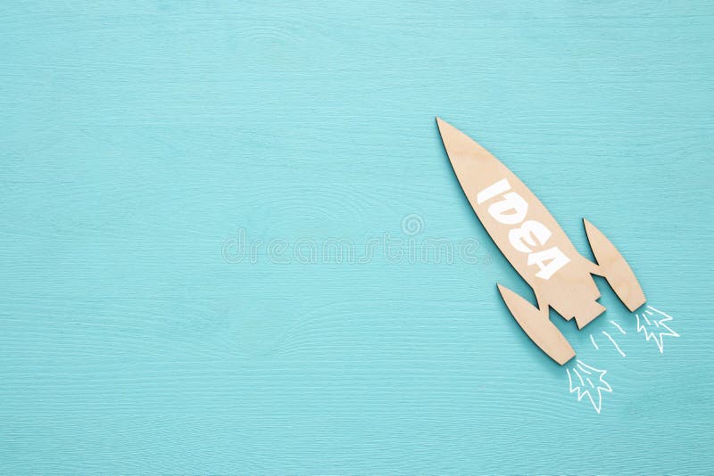 Top View of Wooden Rocket with Word - Idea - Over Blue Background ...