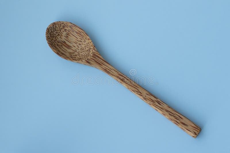 Top View of a Wooden Spoon with Texture on a Blue Background Stock ...