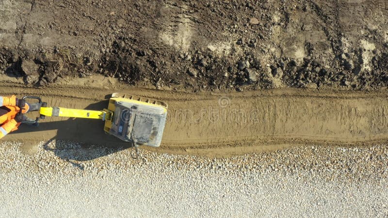 Top View Worker Compacting Foundation Using Vibration Plate Compactor ...
