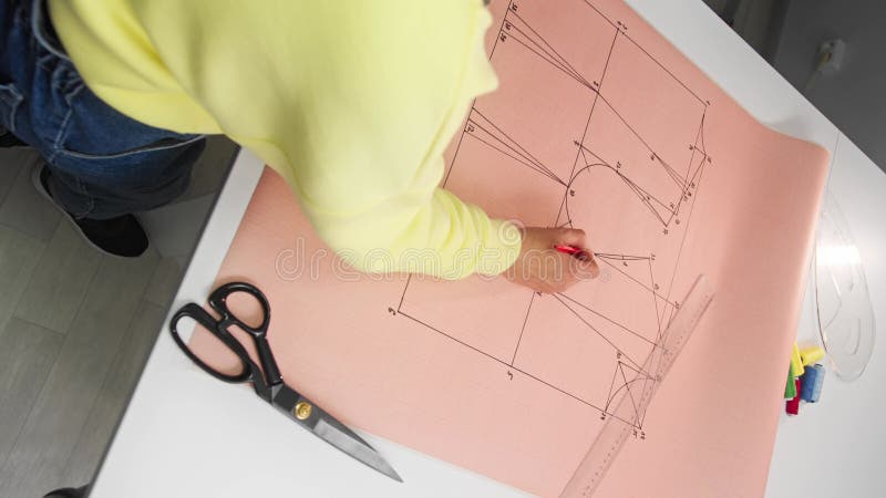 A Top View of a Worker Correcting a Drawing by a Seamstress. Stock ...