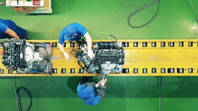 Top View of Workers Using a Conveyor To Assemble a Car Engine Stock ...