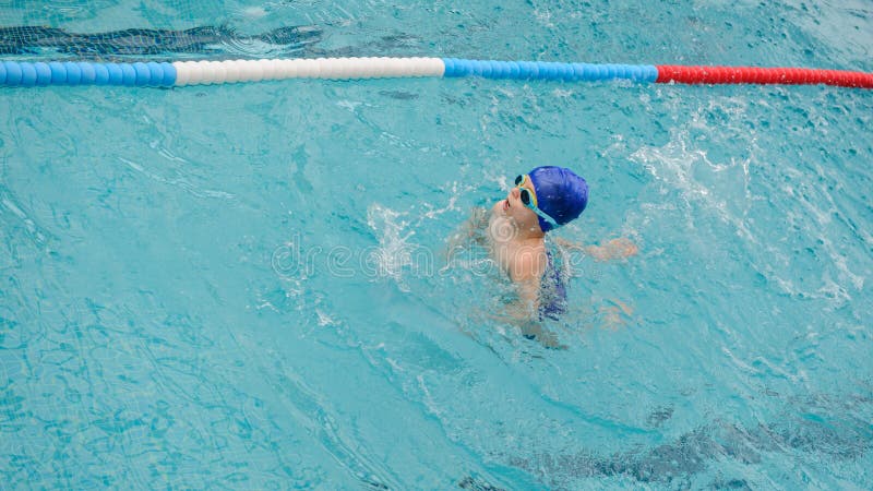 7-year Boy Swimming Backstroke in a Swimming Pool Stock Photo - Image ...
