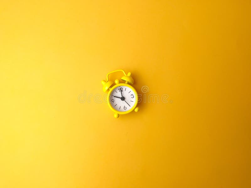Top View Yellow Alarm Clock on a Yellow Background. Stock Photo - Image ...