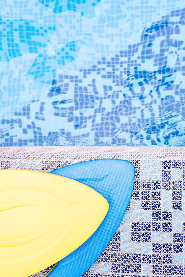 Yellow and Blue Floating Pad Near a Swimming Pool Vertical Composition ...