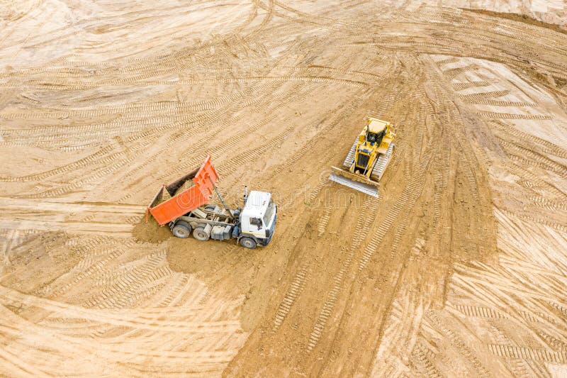 Top View of Yellow Bulldozer and Dump Truck Working at Construction ...