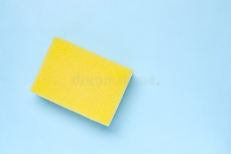 Yellow Cleaning Sponge on Light Blue Background. Stock Photo - Image of ...
