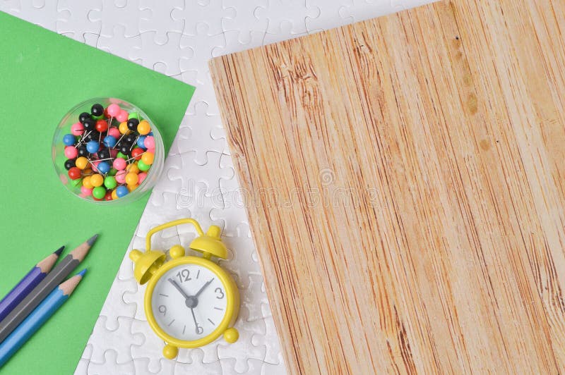 Top View of a Yellow Clock, Pencils, a Notebook and Board Pins on a ...