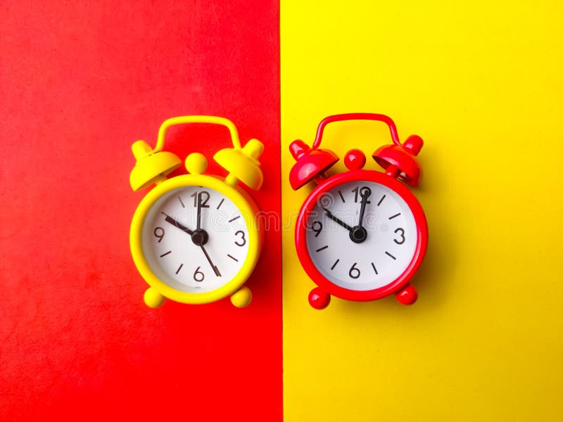 Top View Yellow and Red Alarm Clock on a Red and Yellow Bsckground ...
