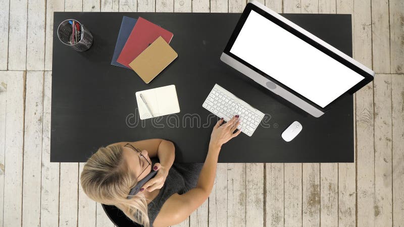 Young Beautiful Woman Working and Talking with Smart Phone and U Stock ...