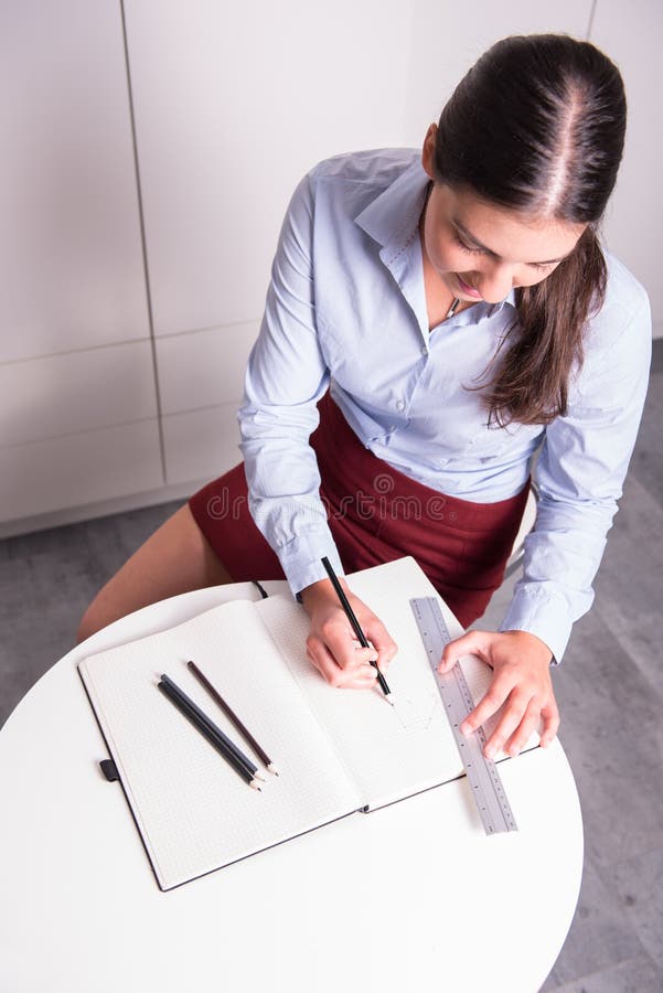 Top View of Young Female Engineer Drawing into Notebook Stock Image ...