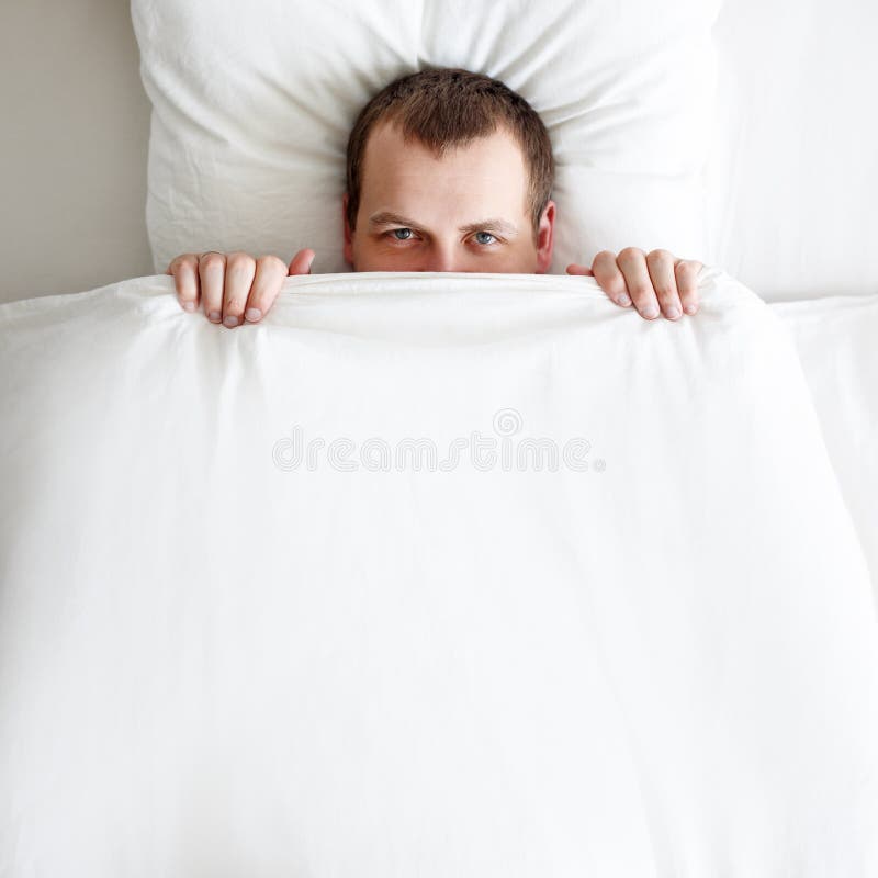 Top View of Young Man Lying in Bed and Covering His Face with Blanket ...