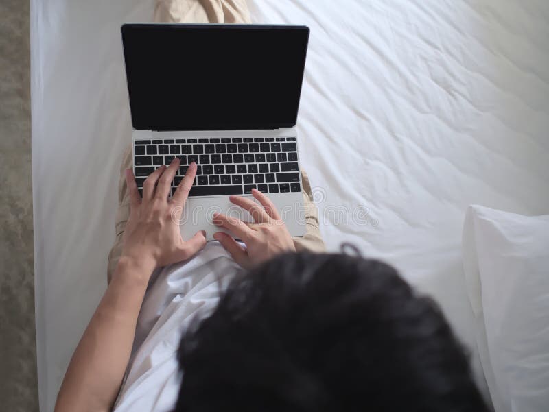 Top View of Young Man Using Computer Laptop on the Bed in Bedroom ...