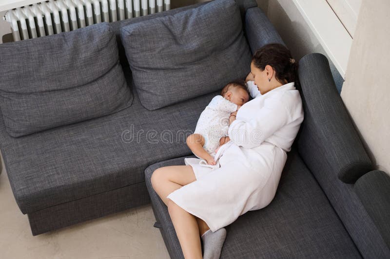 Top View Young Woman In White Waffle Bathrobe Relaxing On The Couch