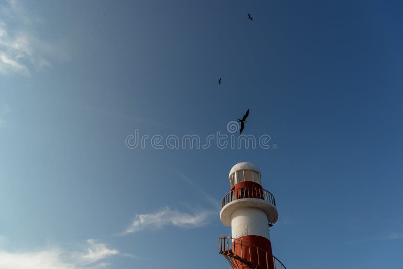 Top of a White-red Lighthouse Against a Blue Sky with an Airplane ...