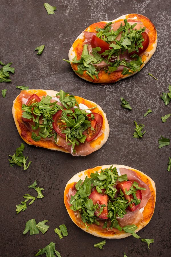 Topview on Three Little Pizza with Tomatoes Stock Photo - Image of ...