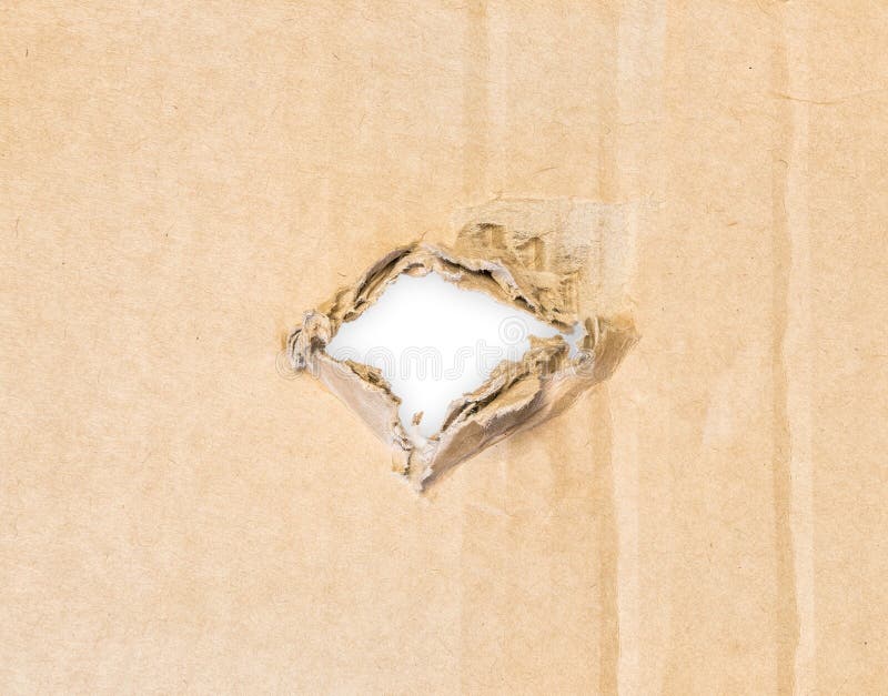 Torn Hole in Cardboard Paper Stock Photo - Image of ragged, scattered ...