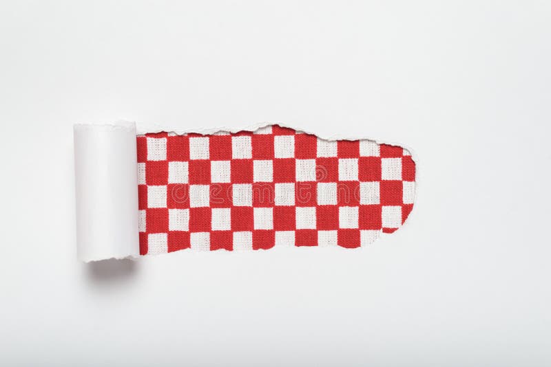 Torn Hole in White Paper Revealing Red and White Checkered Textile ...