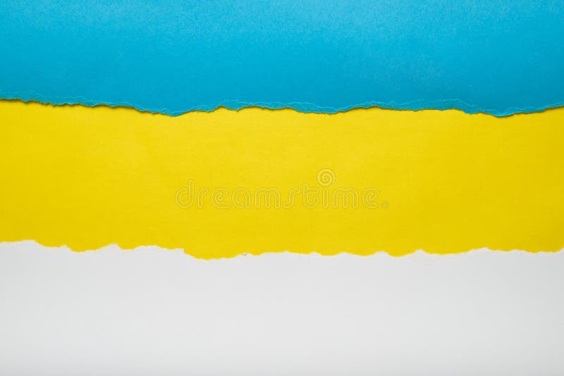 Torn Pieces of Blue and White Paper on Yellow Background. Stock Image ...