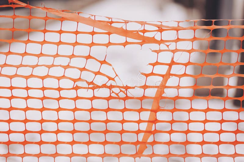 A Torn Section of Bright Orange Safety Netting . a Barrier in an Active ...