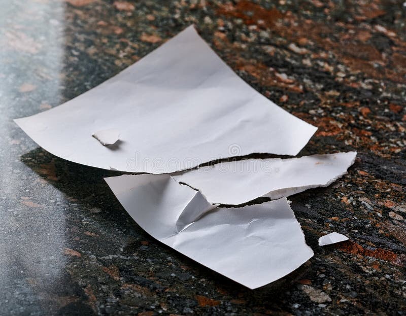 A Torn Sheet of Paper Lying on Polished Granite, Emphasizing Broken ...